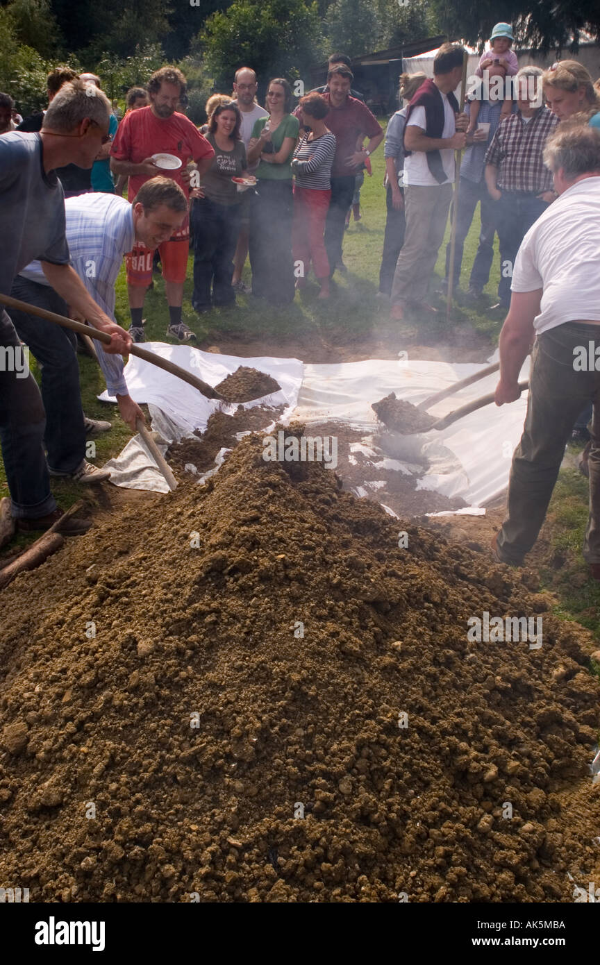 covering the pit oven at a curanto cooking in a pit oven vegetables and ...
