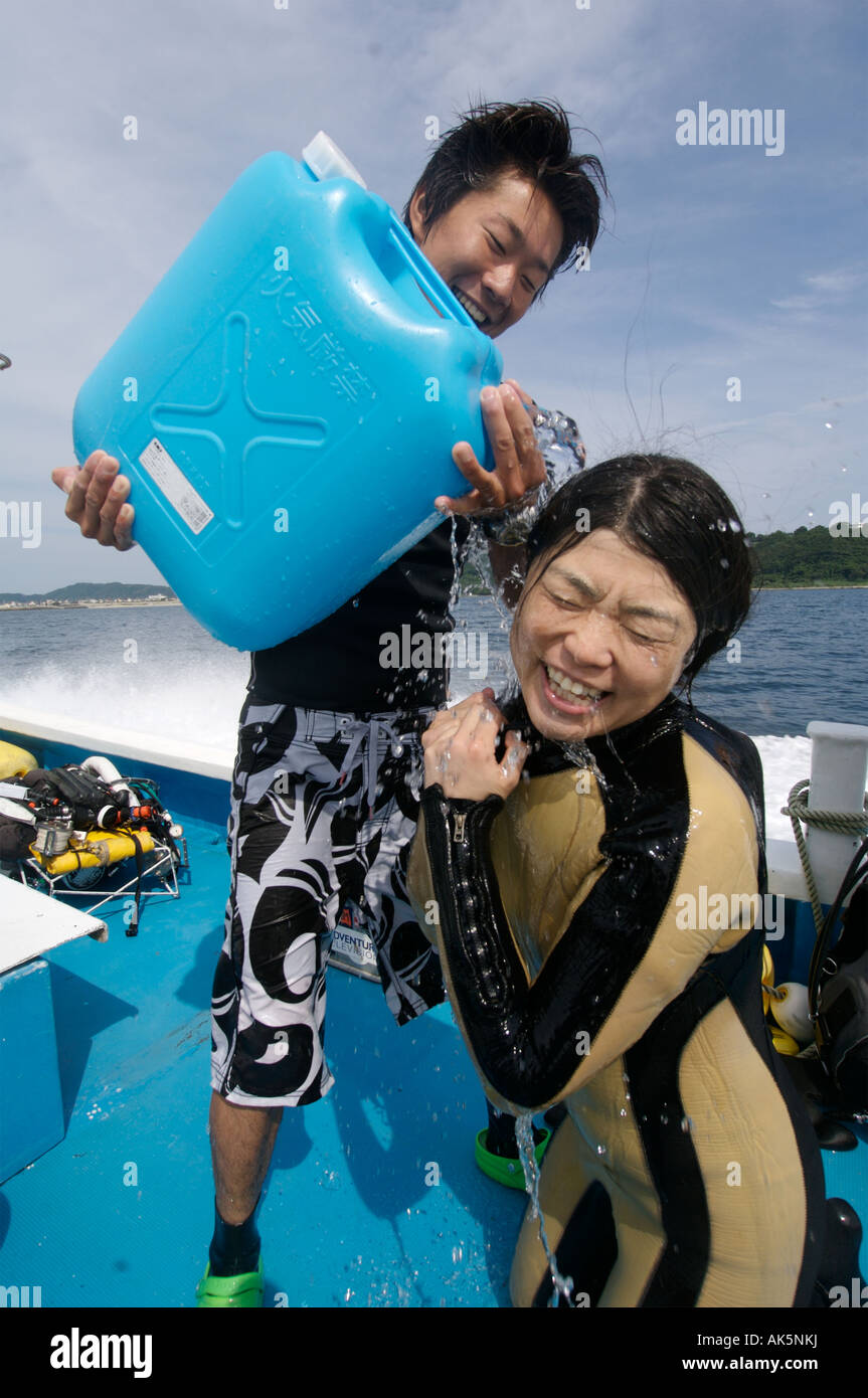 local Japanese dive masters taking shower Stock Photo - Alamy