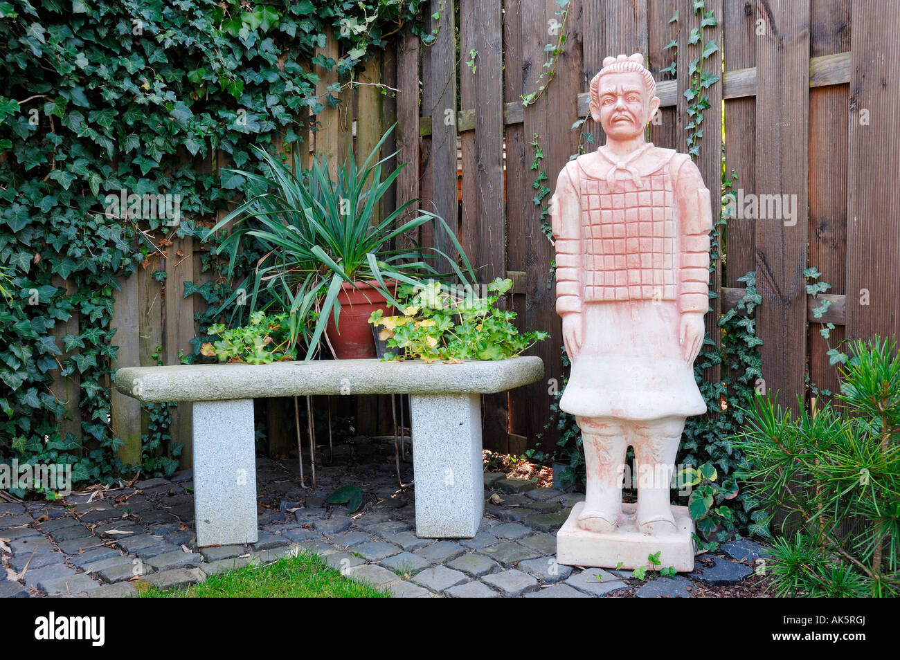 Garden figure and stone bench with plants hi-res stock photography and ...