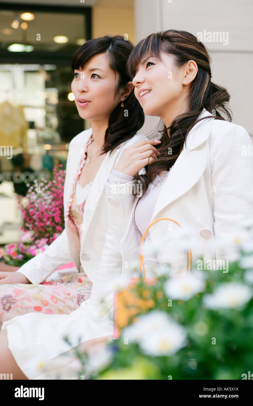 Two women sitting down and relaxing Stock Photo - Alamy
