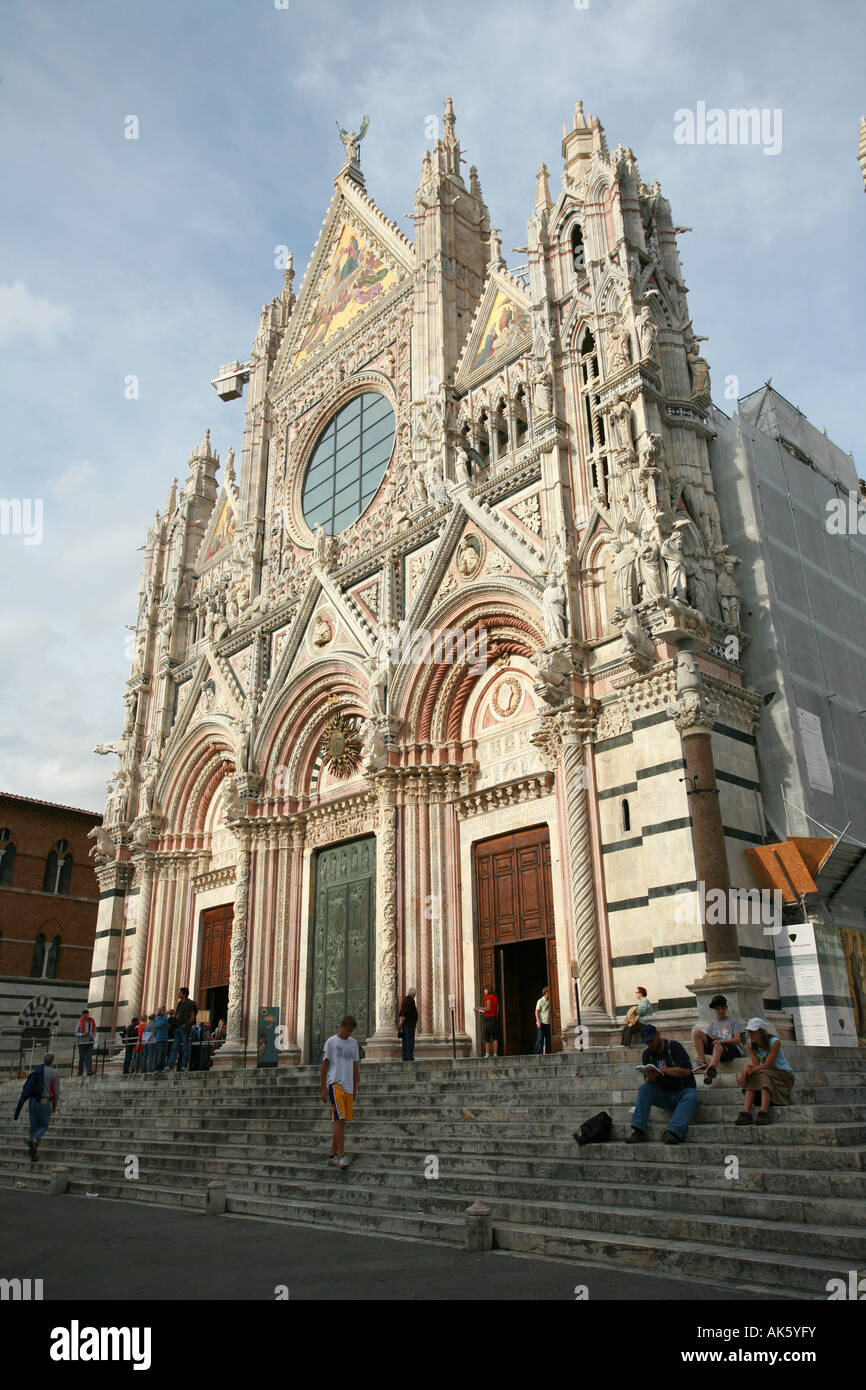 Tourists visit famous Tuscan Romanesque building of Sienna cathedral ...