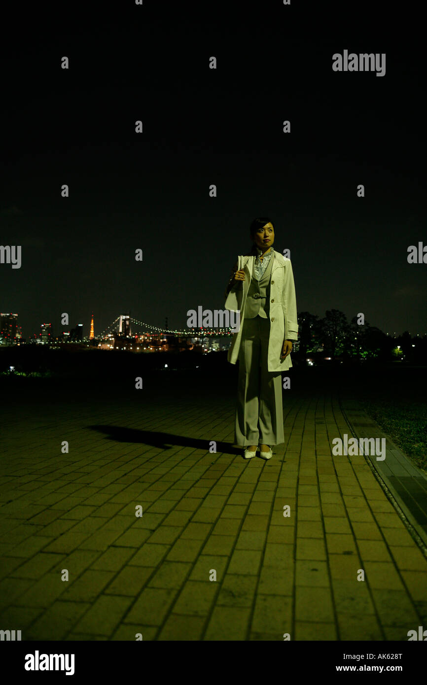 Woman standing alone on street, alone Stock Photo - Alamy