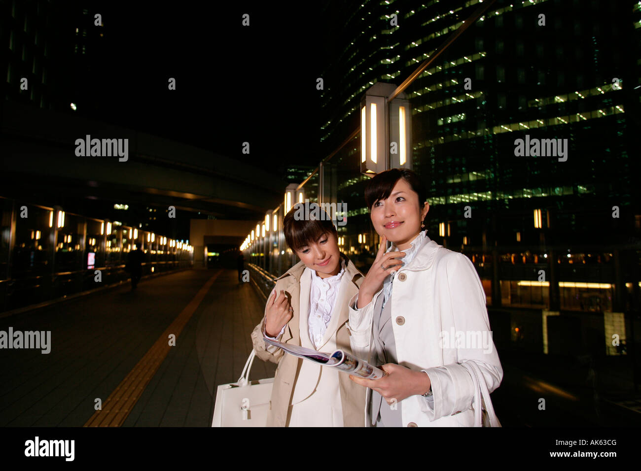 Two women standing on the street at night Stock Photo - Alamy