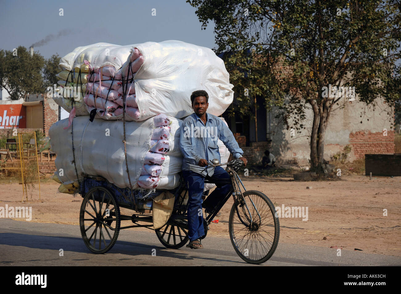 Indian man with loaded cycle rickshaw hi-res stock photography and ...