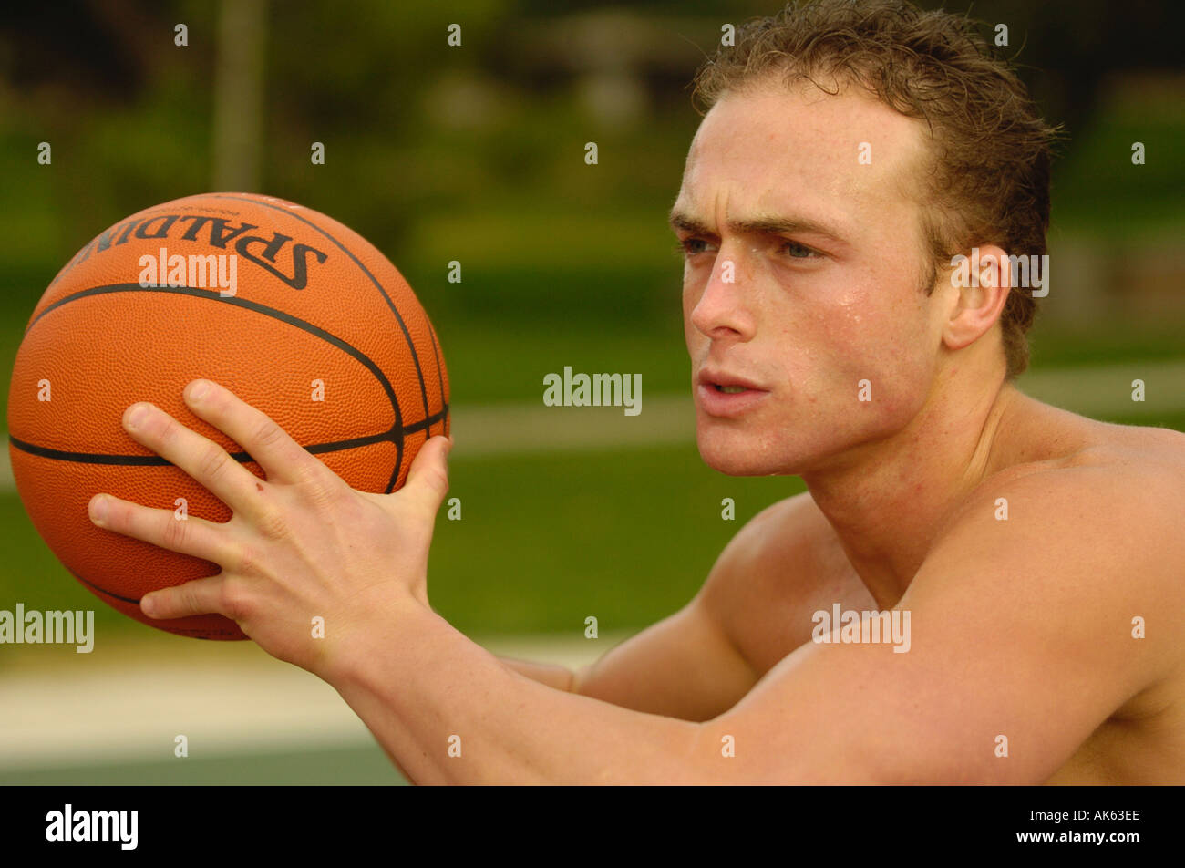 A man playing one on one baskeball in a park Stock Photo - Alamy