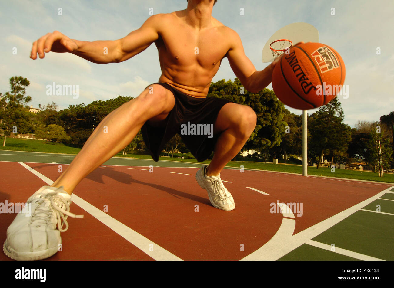 A man playing one on one baskeball in a park Stock Photo - Alamy