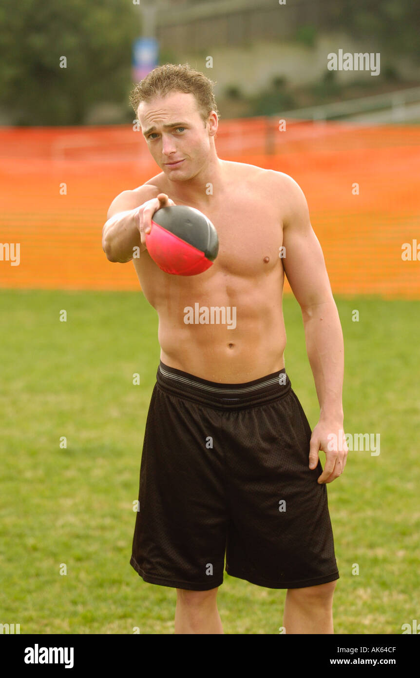 A man playing touch American football in a park and celebrating a ...