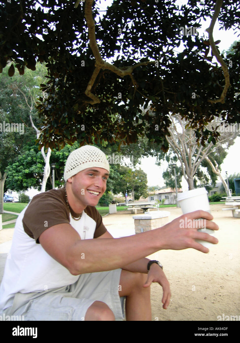 A man sits on a park bench and drinks coffee Stock Photo - Alamy