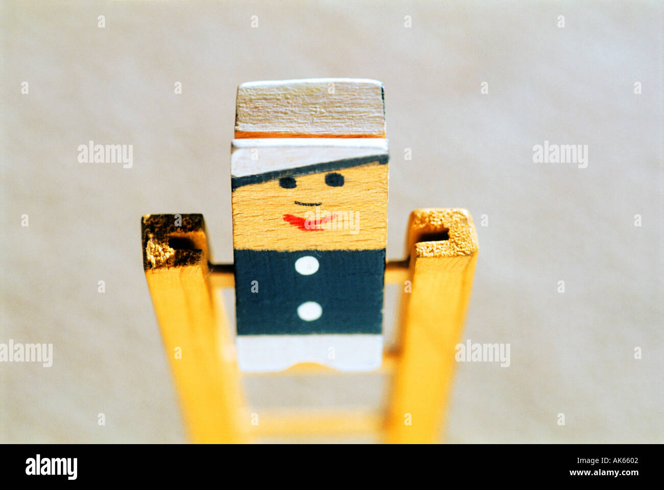 Miniature man on ladder Stock Photo - Alamy
