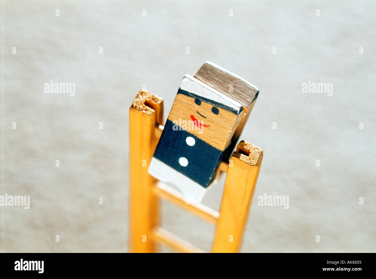Miniature man on ladder Stock Photo - Alamy