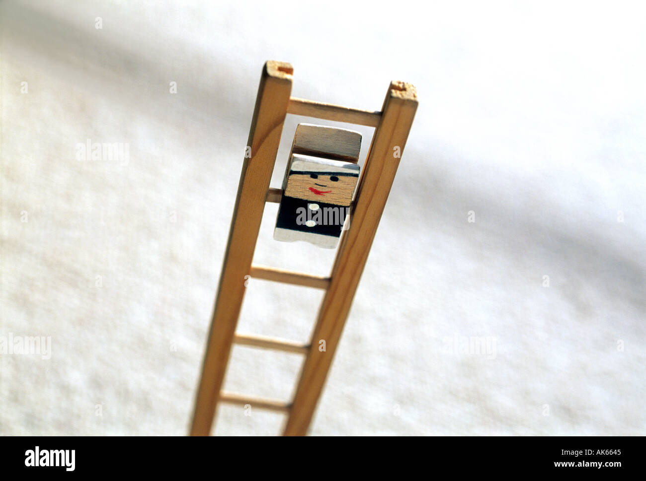 Miniature man on ladder Stock Photo - Alamy