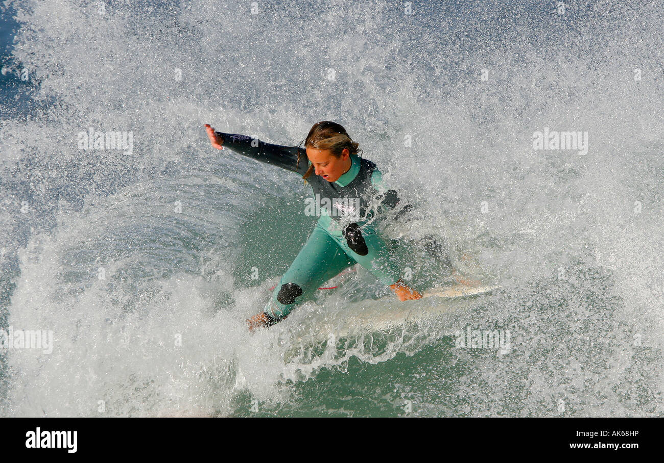 A female surfer practices on a wave with his surfboard in the Hossegor ...