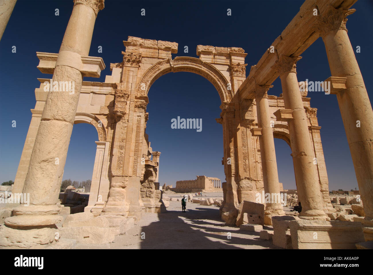 Arch of Triumph, Palmyra, with Temple of Baal in background. Person ...