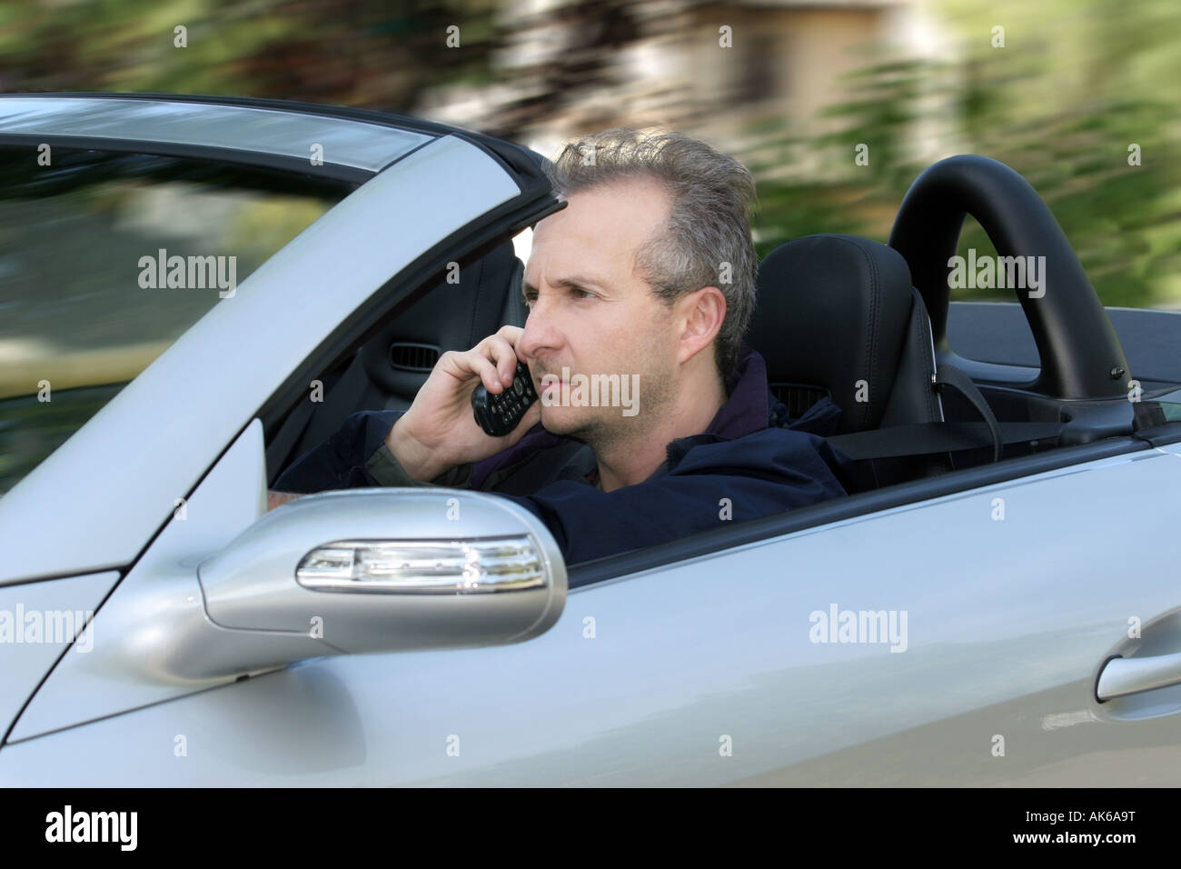 Man driving a convertible car Stock Photo - Alamy