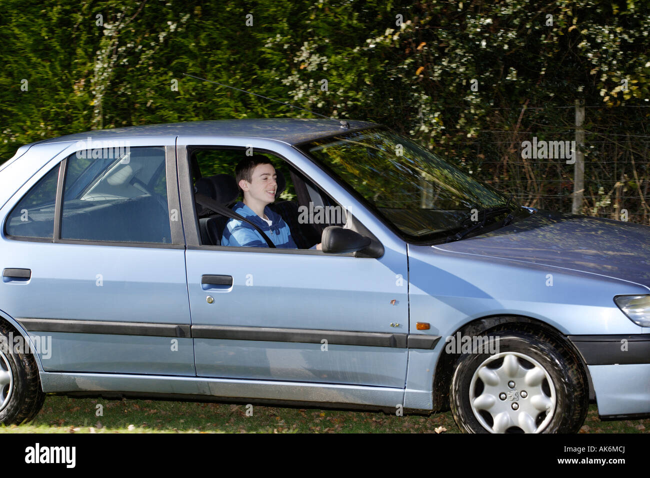 Boy learning to drive his fathers car in a field Stock Photo - Alamy