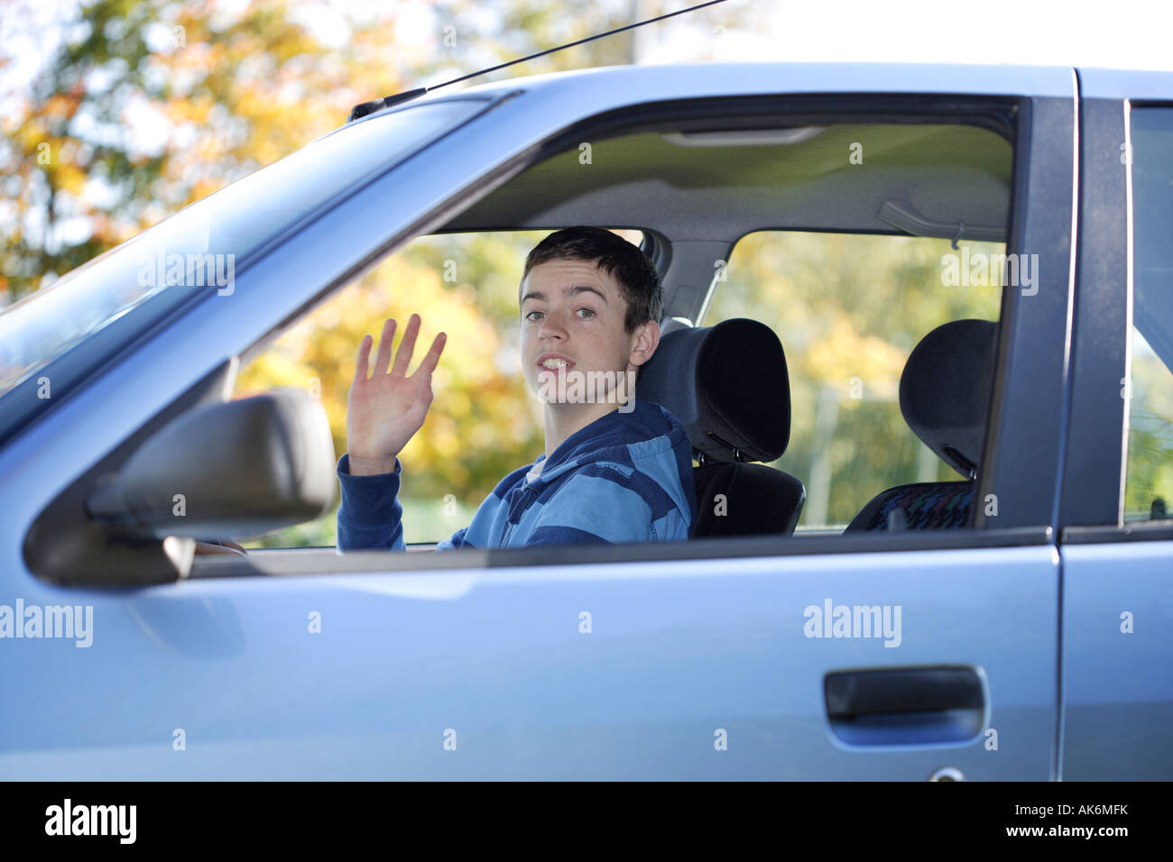 Boy learning to drive his fathers car in a field Stock Photo - Alamy