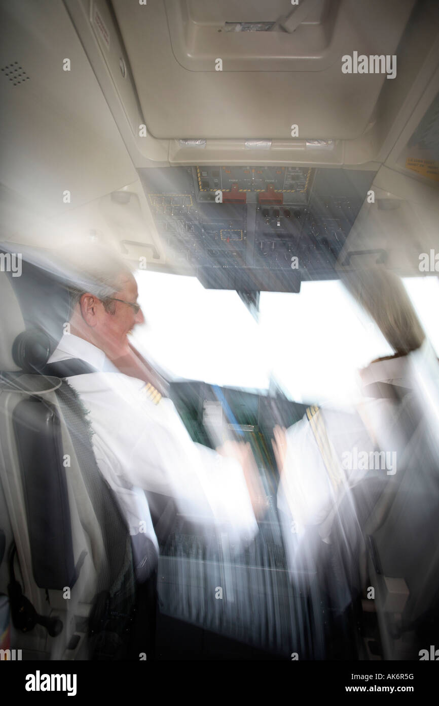 Pilots in cockpit of passenger jet Stock Photo - Alamy