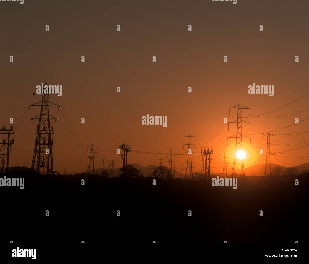 Electricity Pylons at Sunset Stock Photo - Alamy