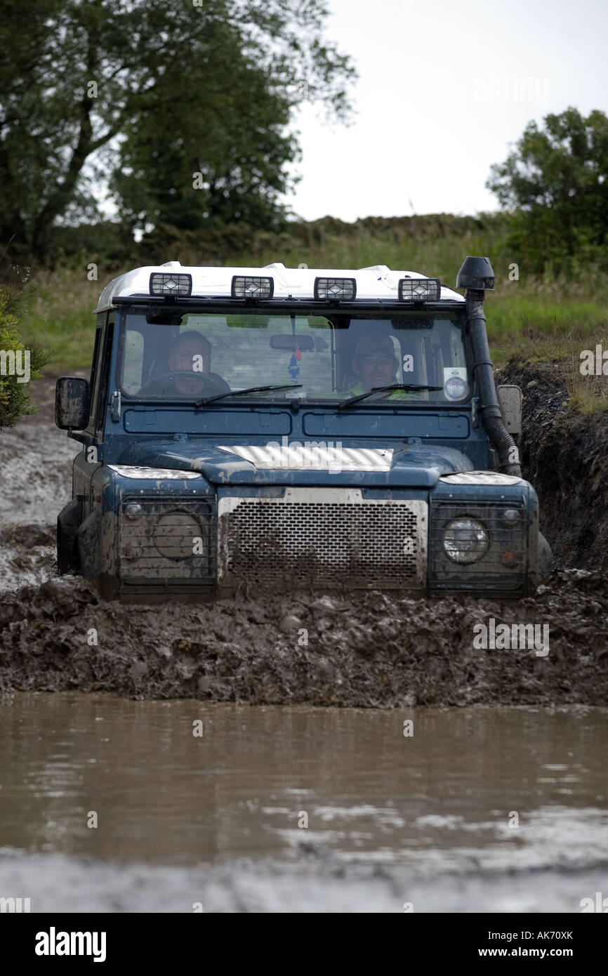 Land Rover Defender fording muddy water Stock Photo - Alamy
