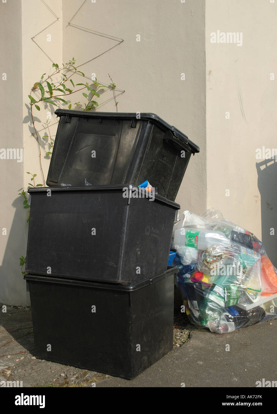 Black plastic recycle waste bins awaiting collection Stock Photo - Alamy