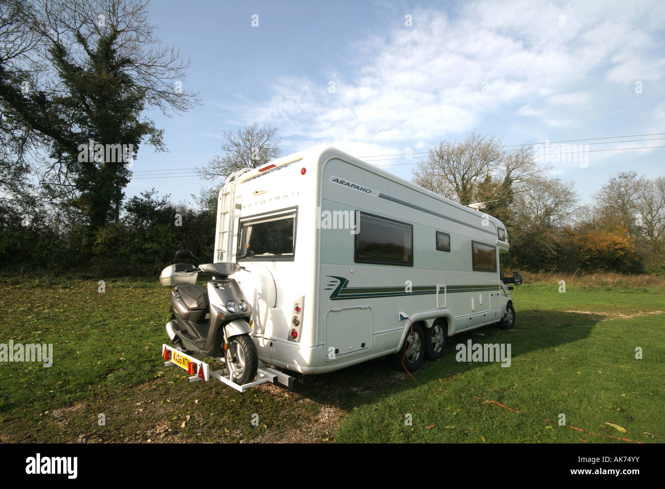 motorhome with scooter camped in the middle of a field enjoying the ...