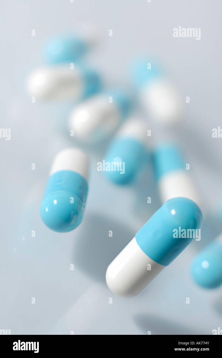 White blue capsules Medication pills Stock Photo - Alamy