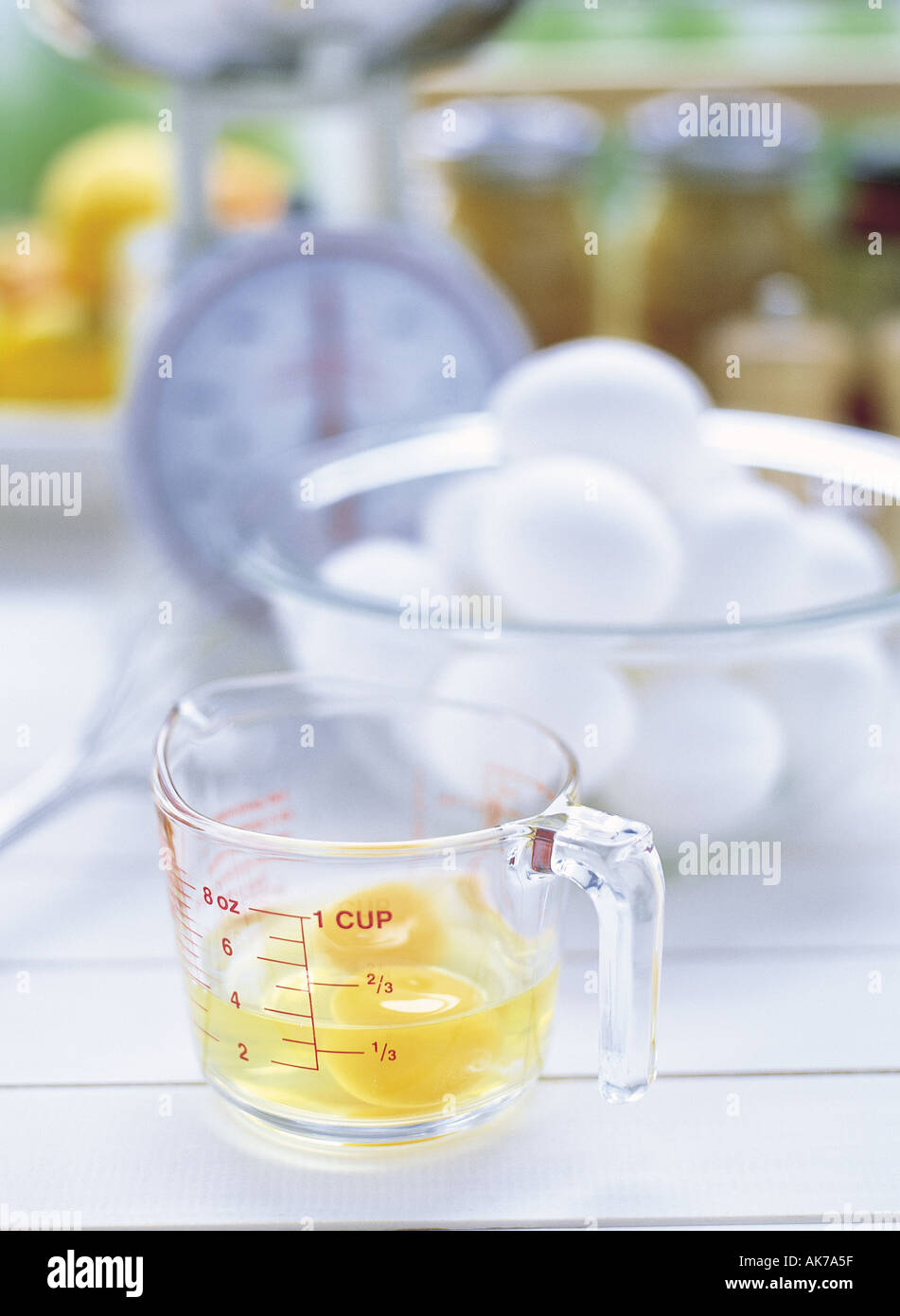 Eggs in measuring cup bowl Stock Photo - Alamy