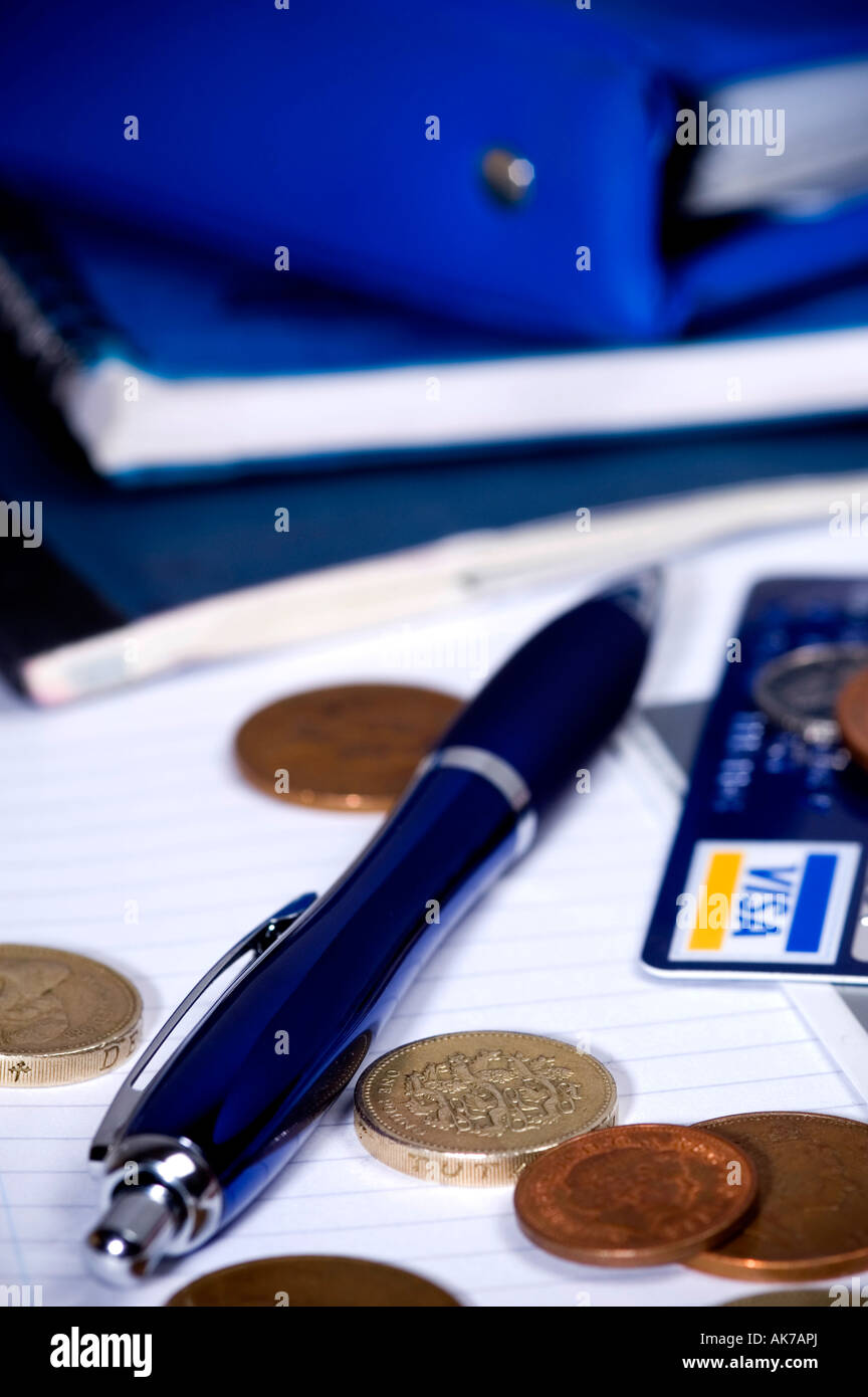 Blue pen coins and debit card Stock Photo - Alamy