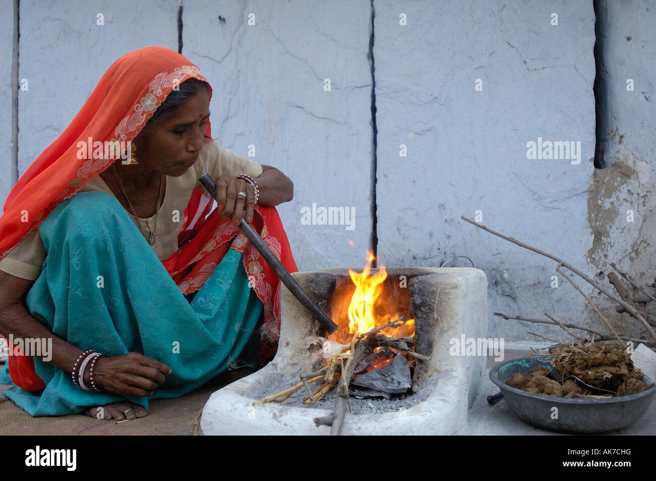 Rajasthani village woman preparing cooking fire in the morning. Pushkar ...