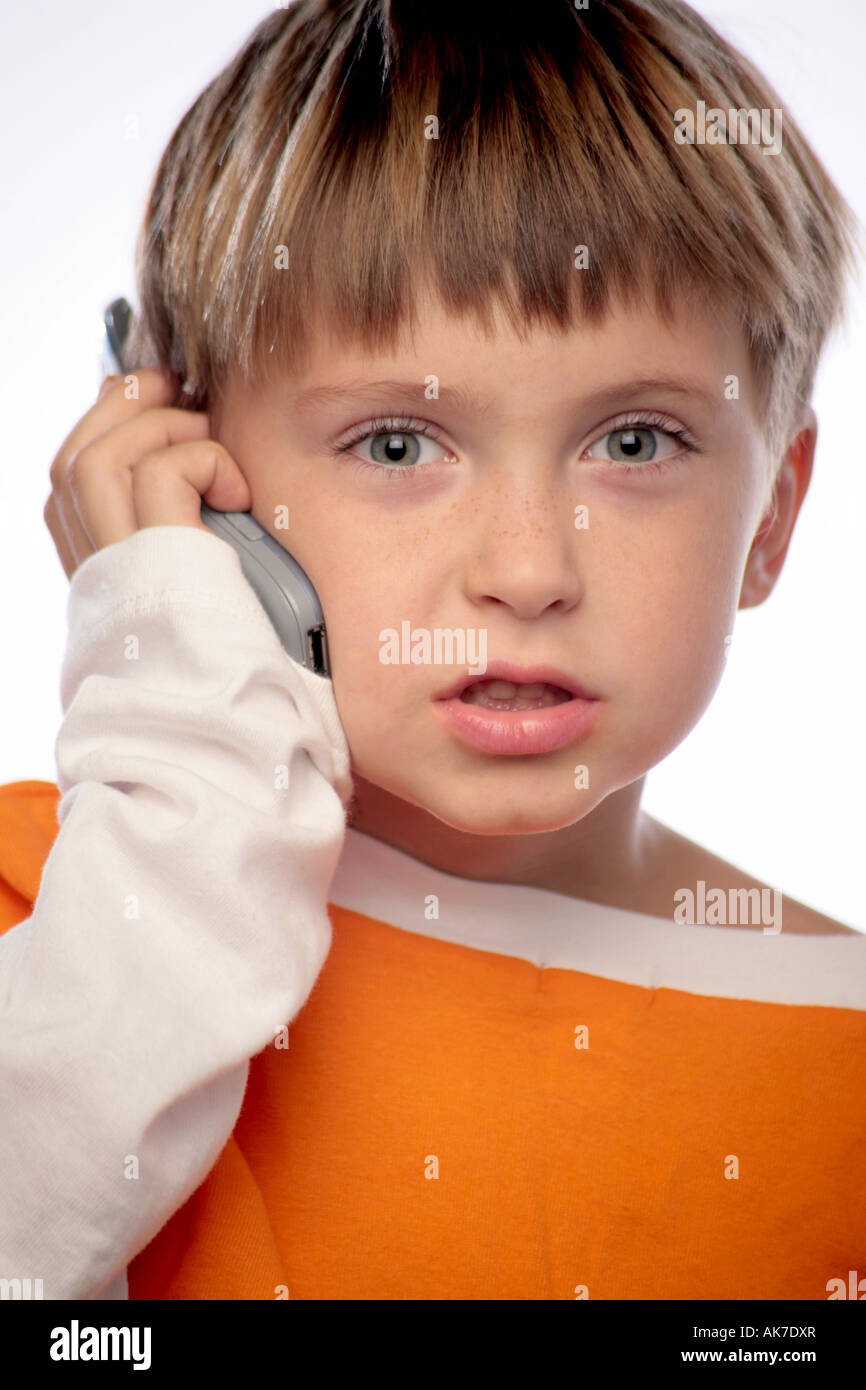 Photo of a little boy talking on a cellphone He s in the middle of a ...
