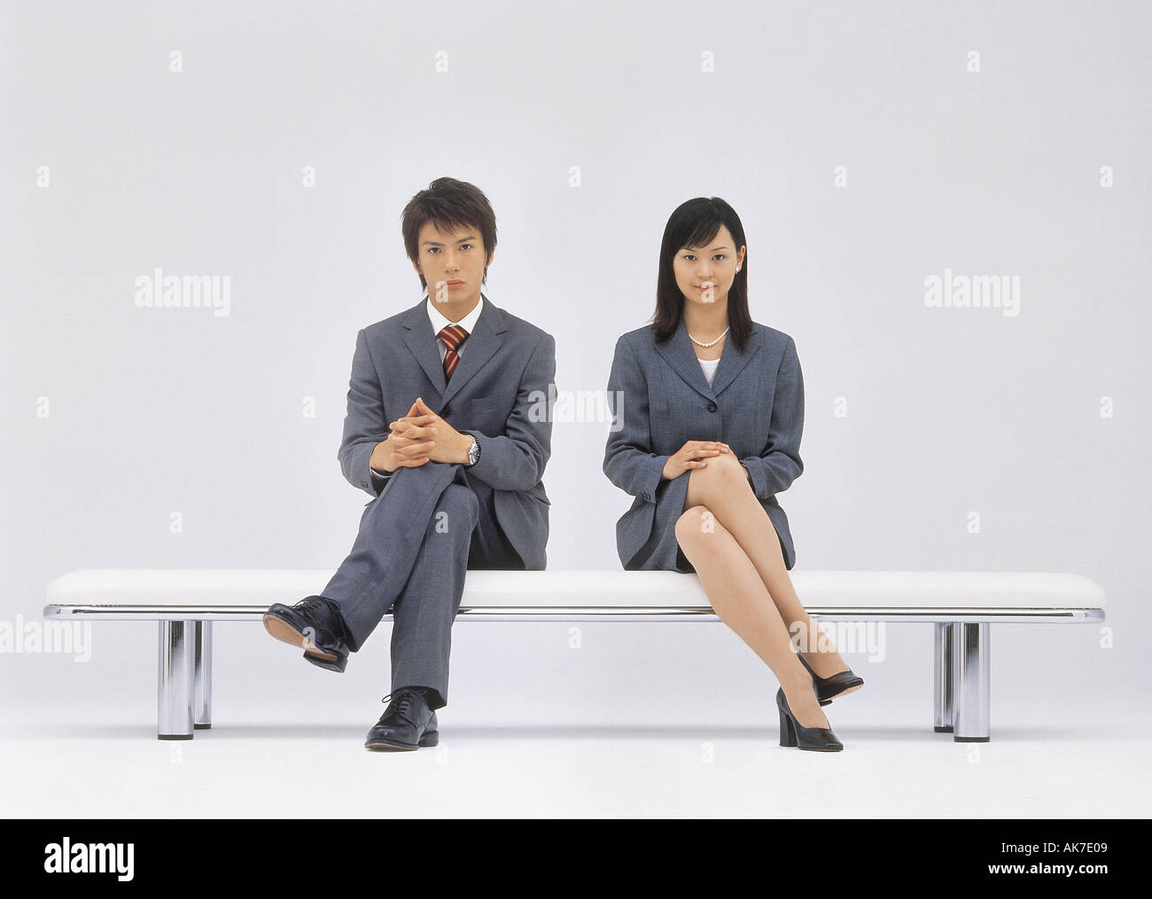 Business people sitting on bench Stock Photo - Alamy
