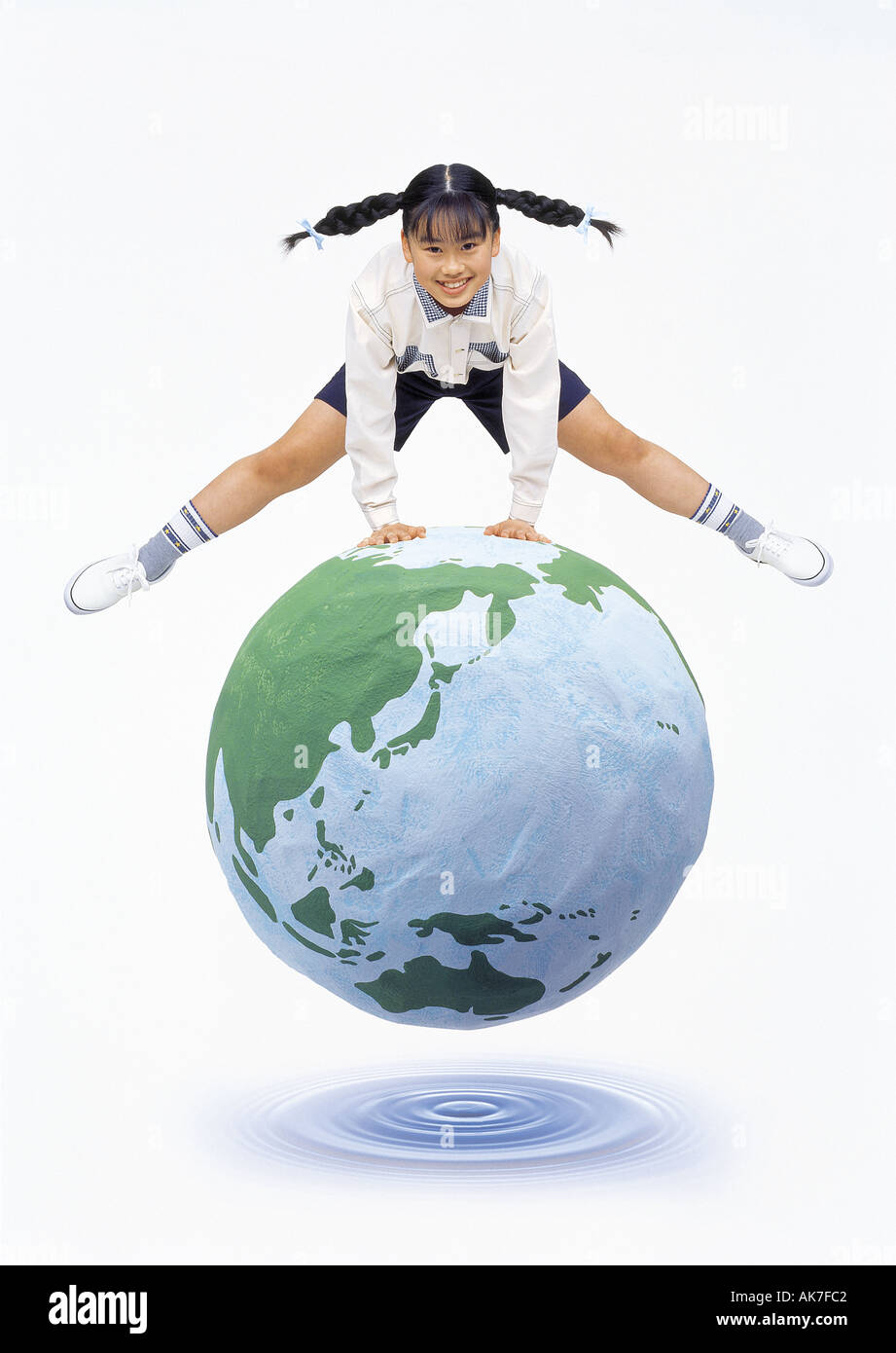Girl jumping over earth Stock Photo - Alamy
