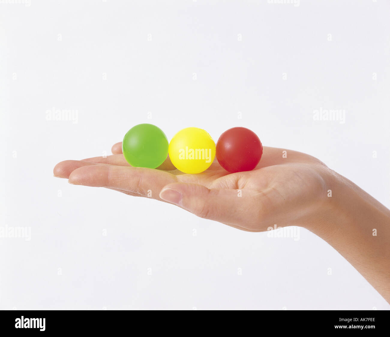 Hand holding colorful balls Stock Photo - Alamy