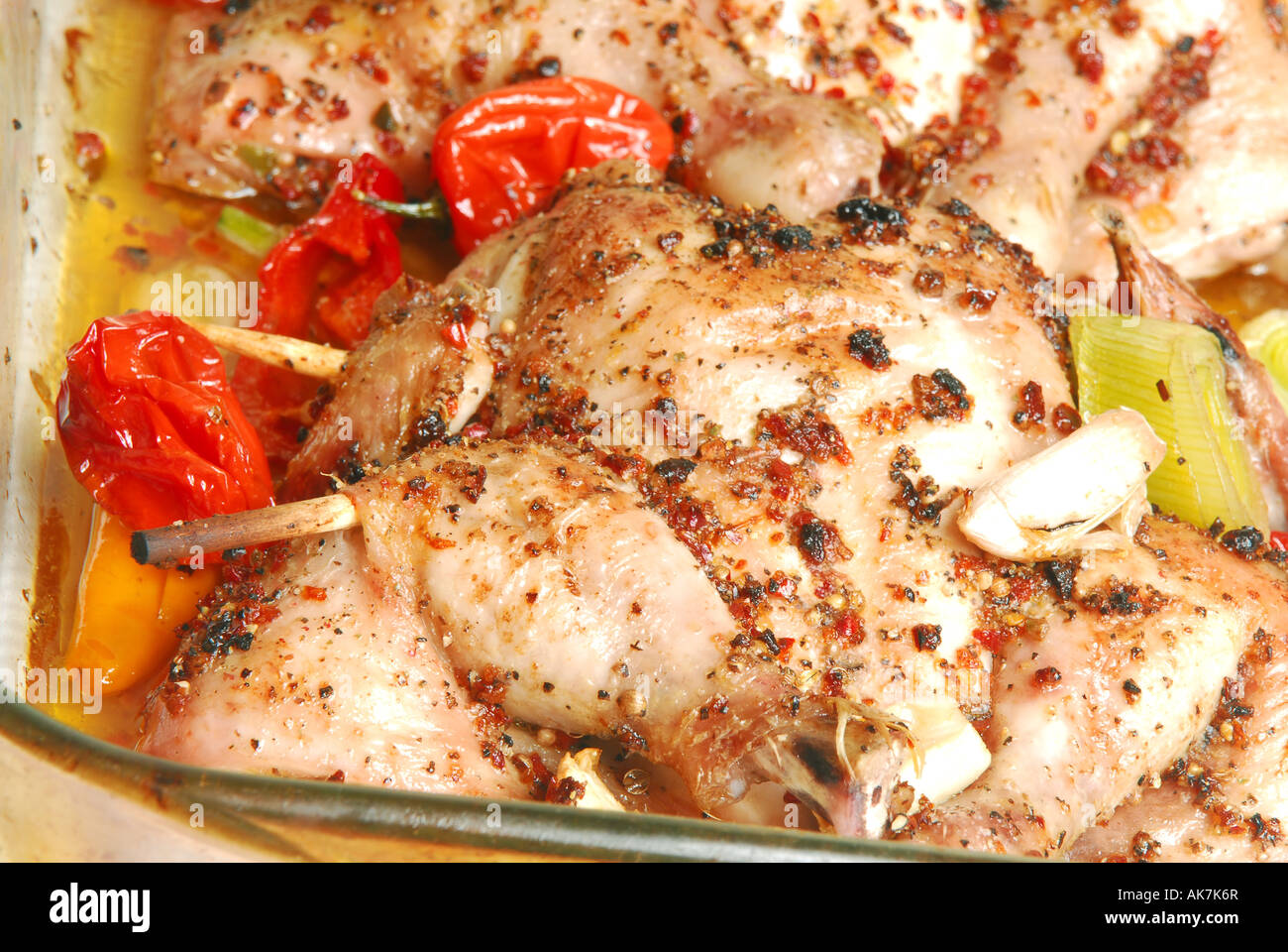 Skewered roast poussins in roasting dish Stock Photo - Alamy