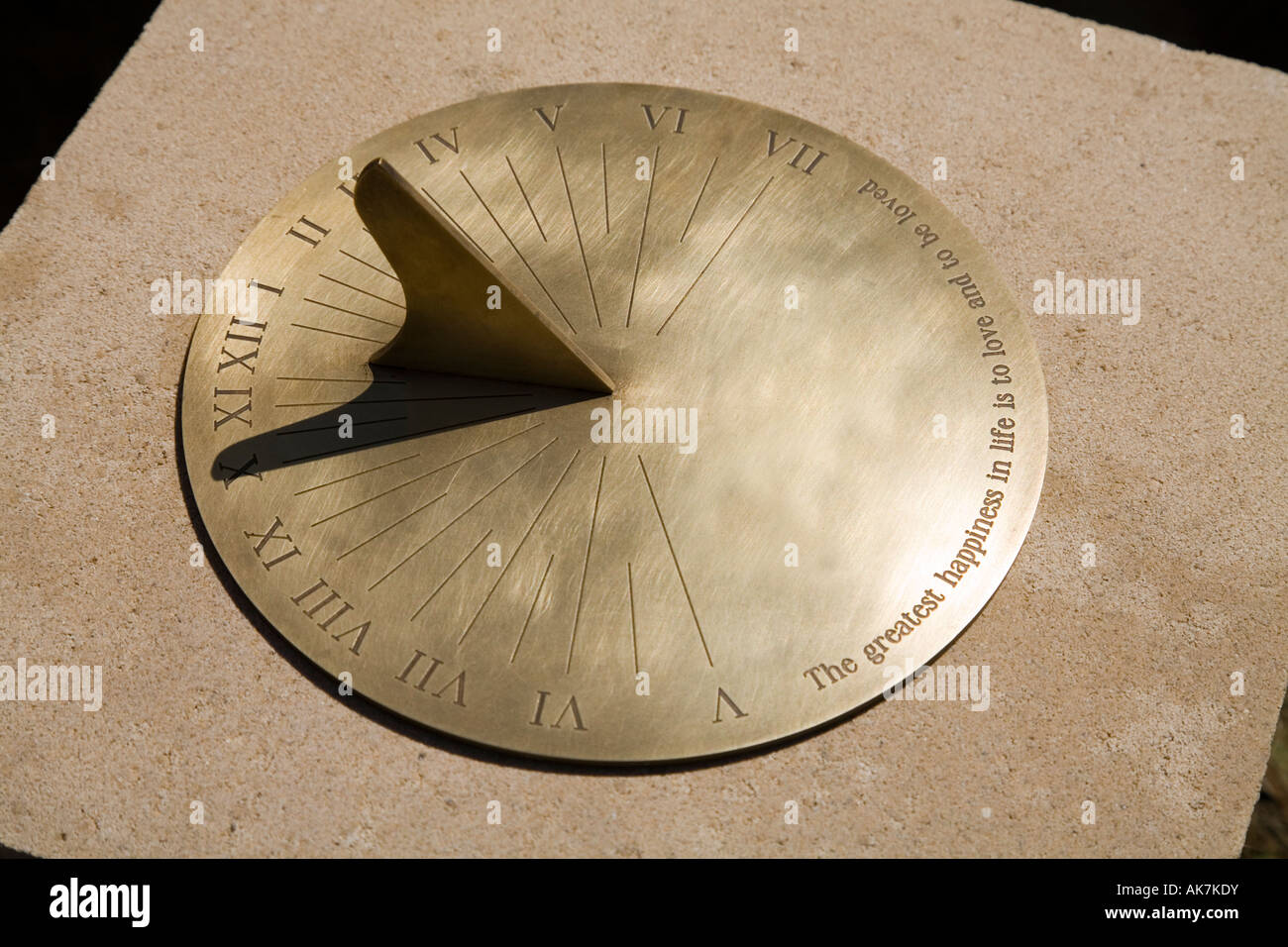 Brass sundial mounted on a stone plynth Stock Photo - Alamy