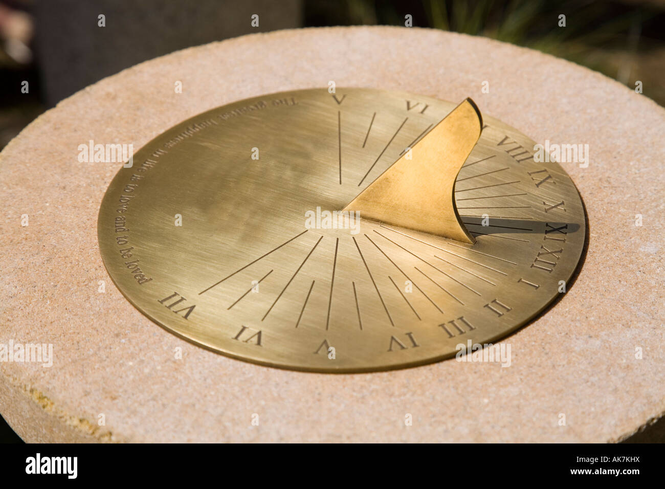 Brass sundial mounted on a stone plinth Stock Photo - Alamy