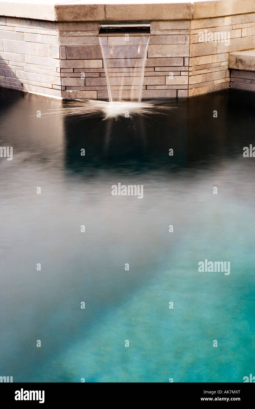 Waterfall from Stone Jacuzzi to Swimming Pool Stock Photo - Alamy
