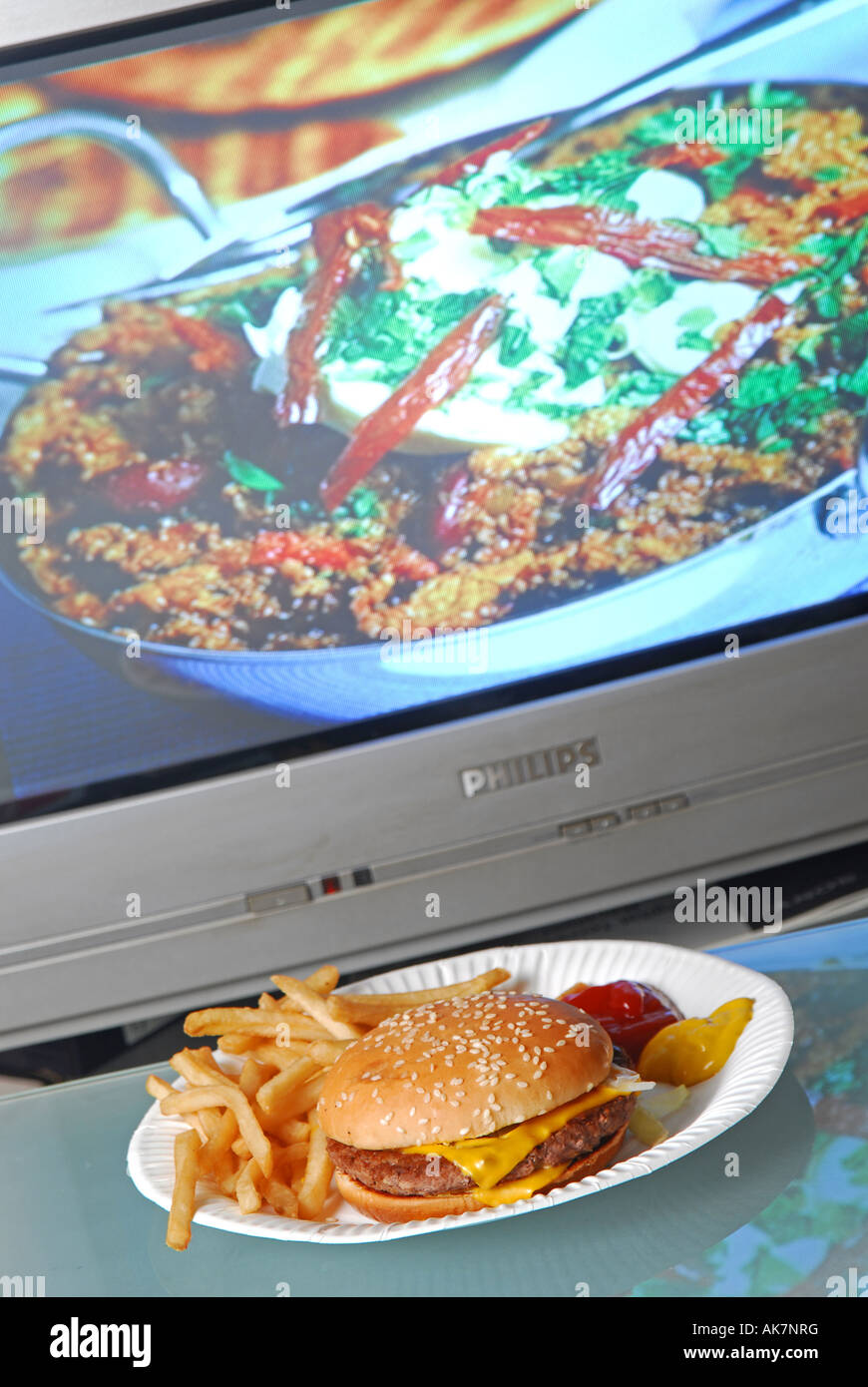 Concept shot to show unhealthy fast food TV dinner in front of ...