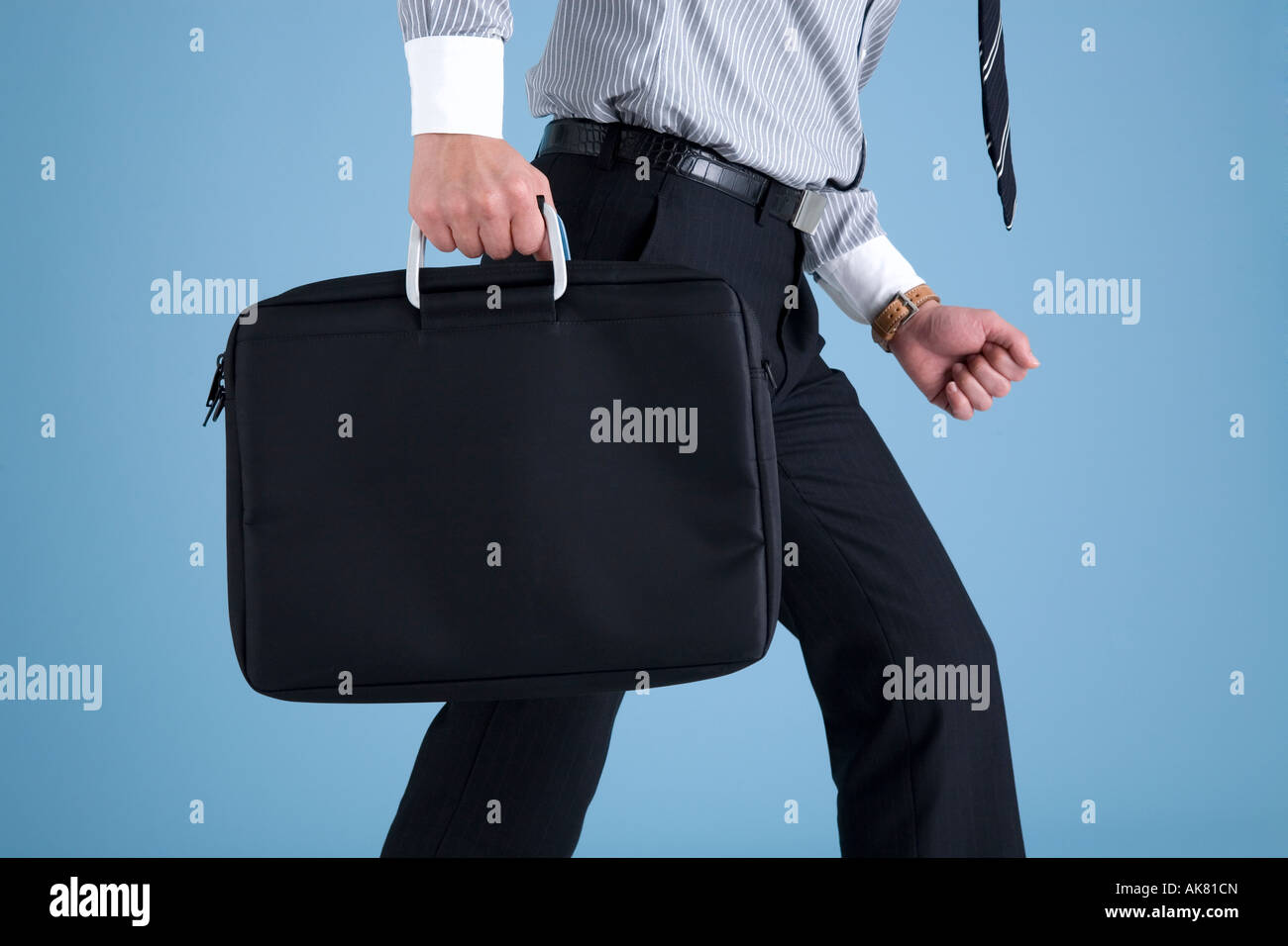 Businessman holding bag Stock Photo - Alamy