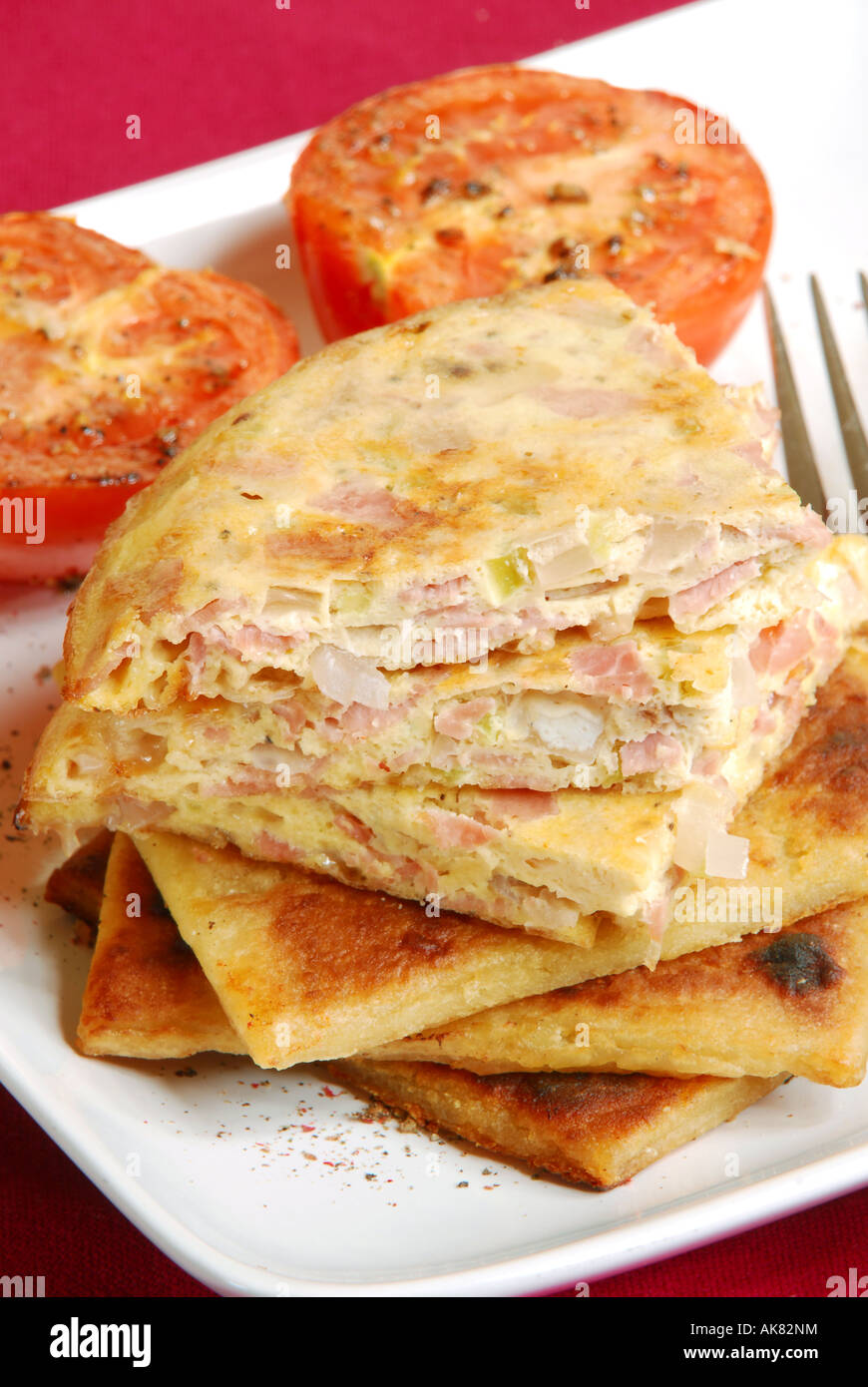A breakfast of cheese and bacon omelette slices on Irish farls (potato ...