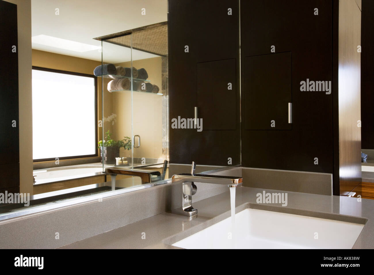 Modern Bathroom Vanity with Reflection of Jacuzzi Tub Stock Photo - Alamy