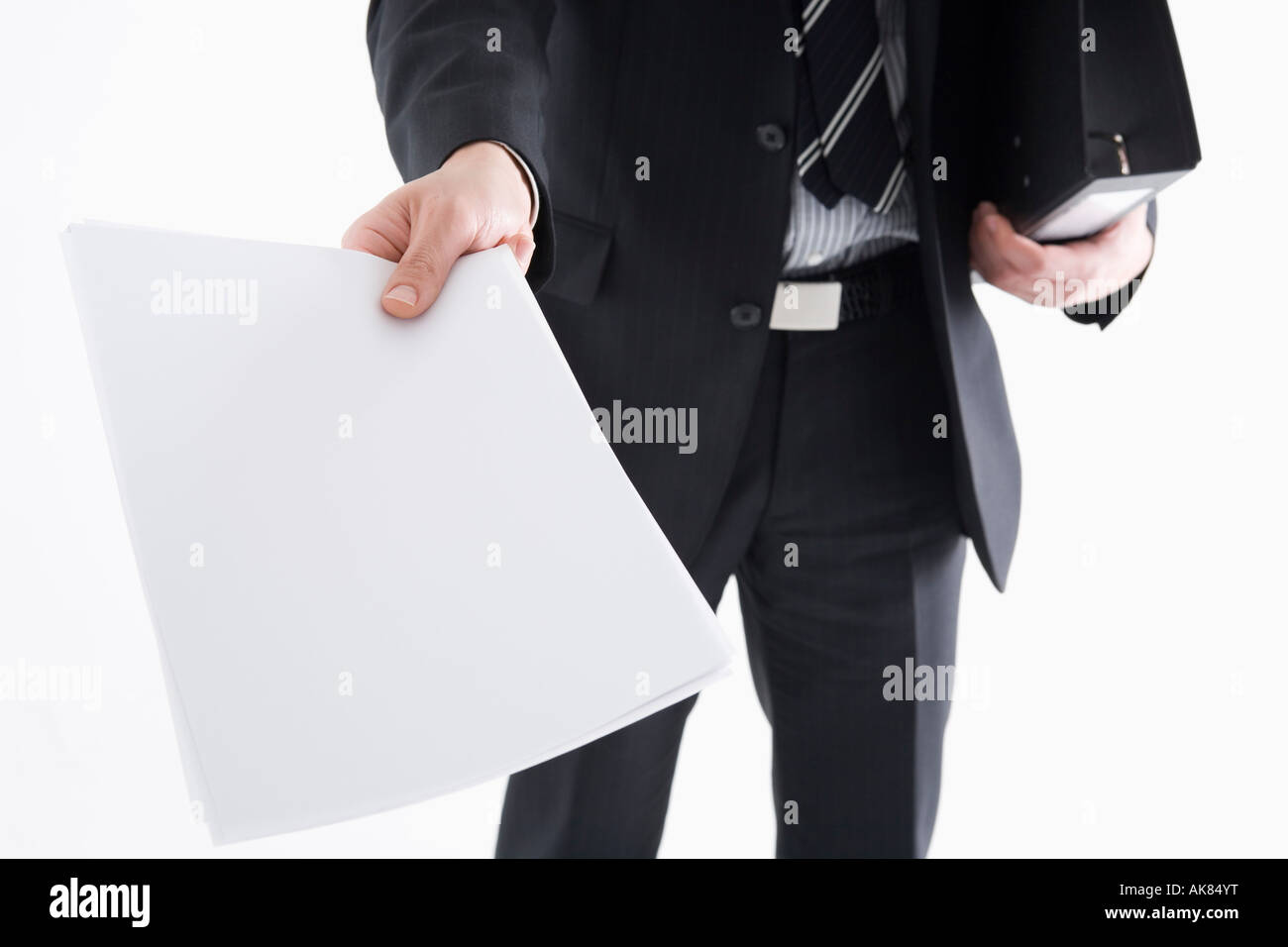 Businessman holding sheet of paper Stock Photo - Alamy
