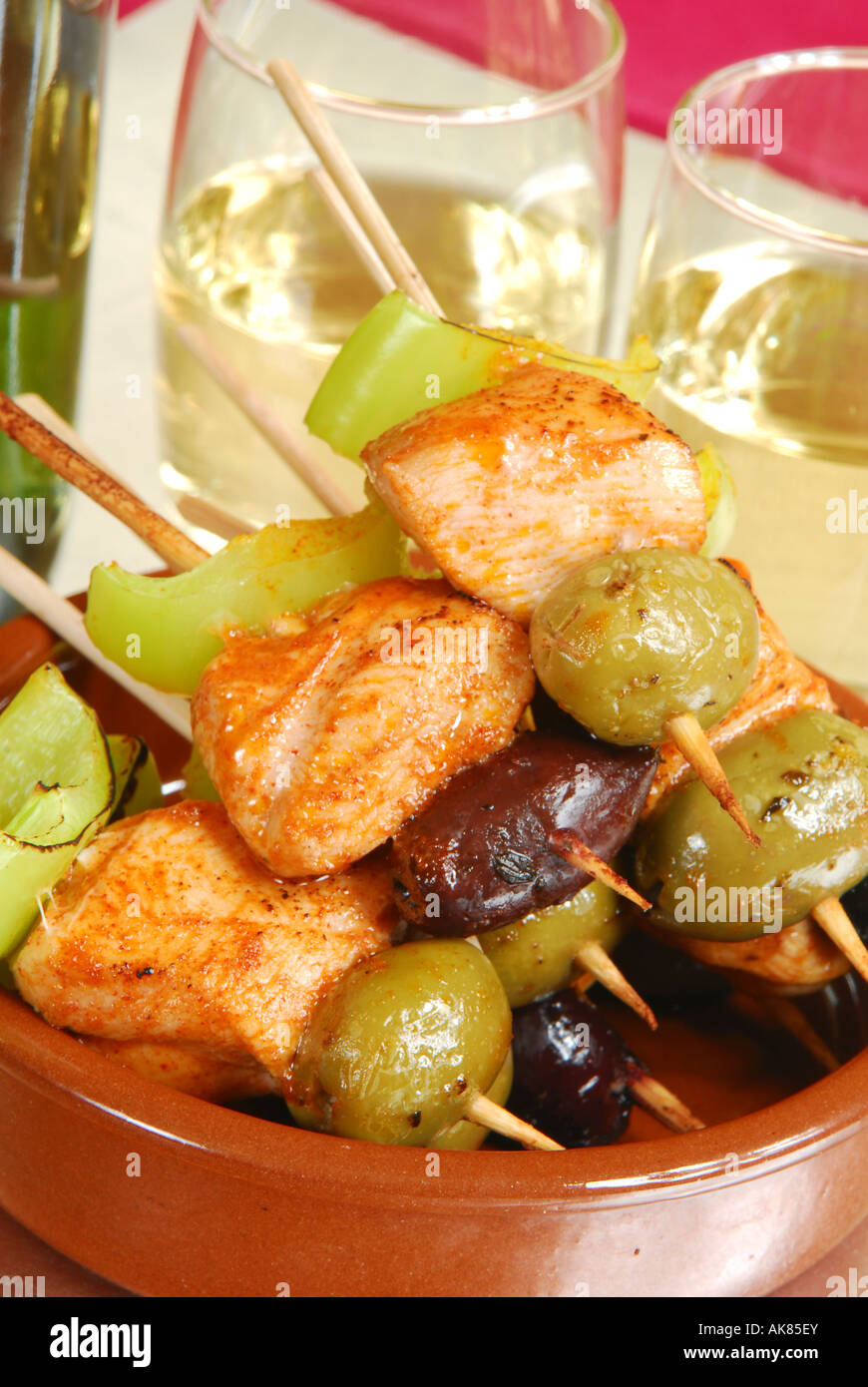 Spanish-style tapas of chicken, olive and pepper pinchitos in a ...