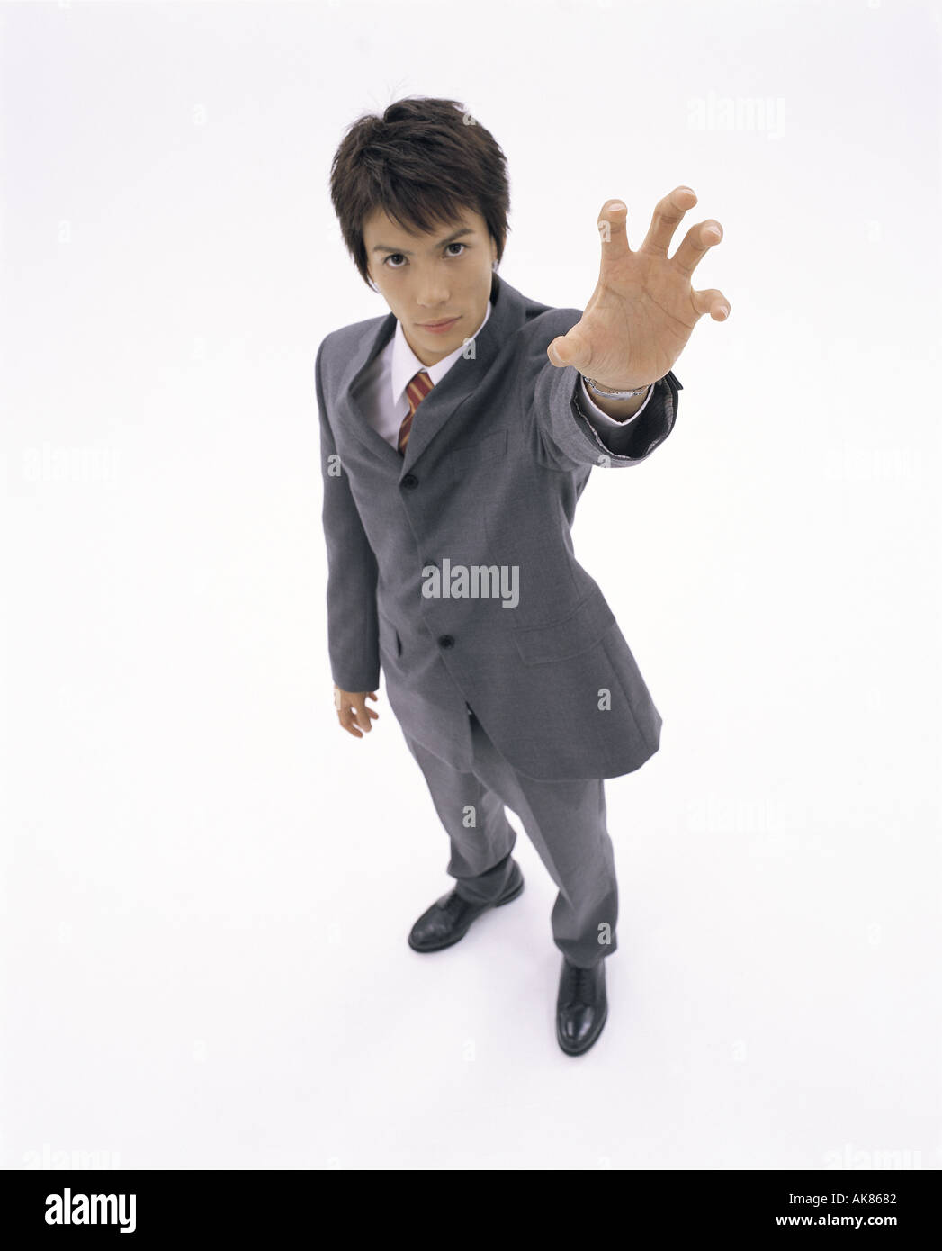 Businessman grabbing something Stock Photo - Alamy