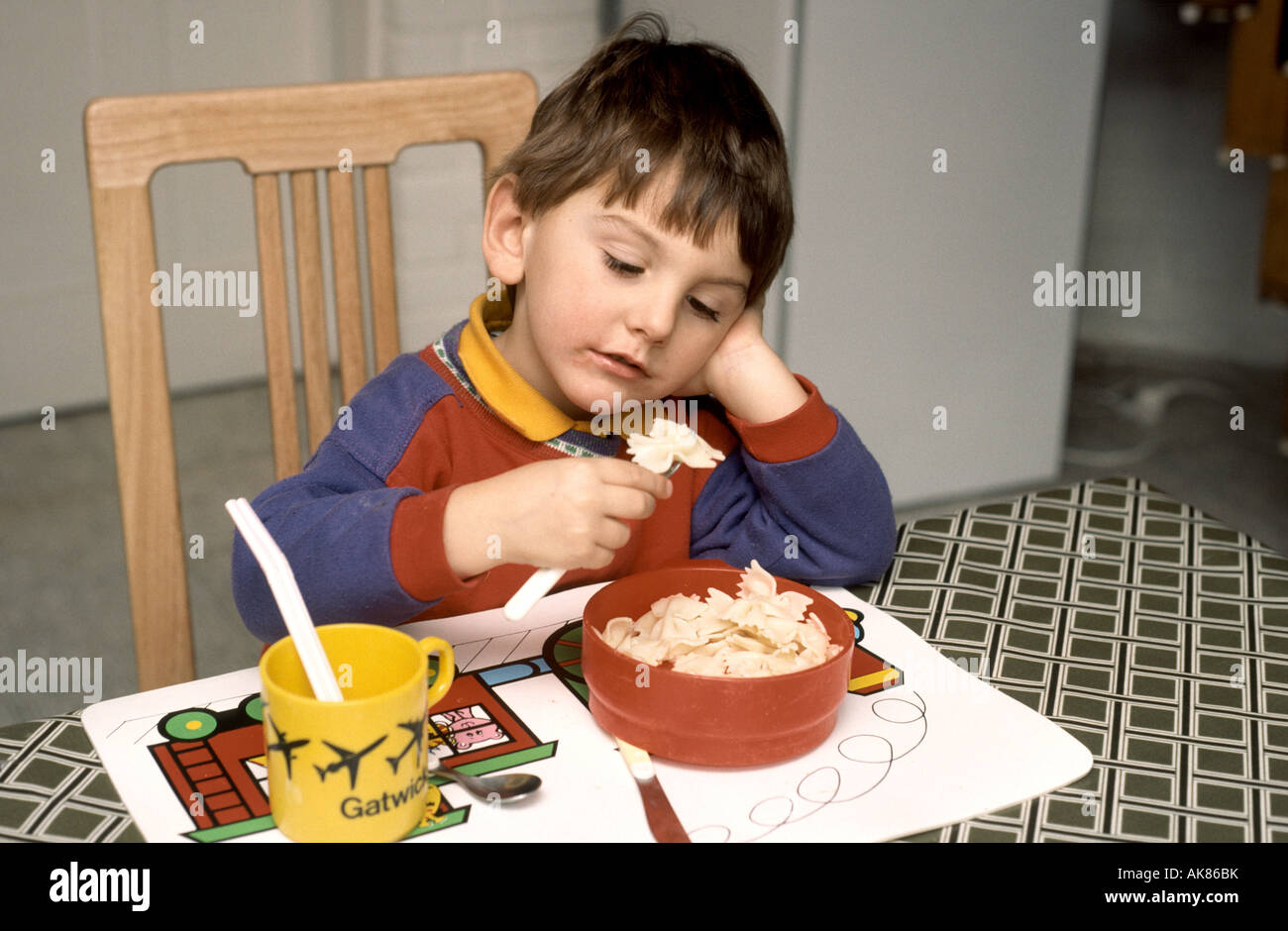 Three year old boy eating pasta Stock Photo - Alamy