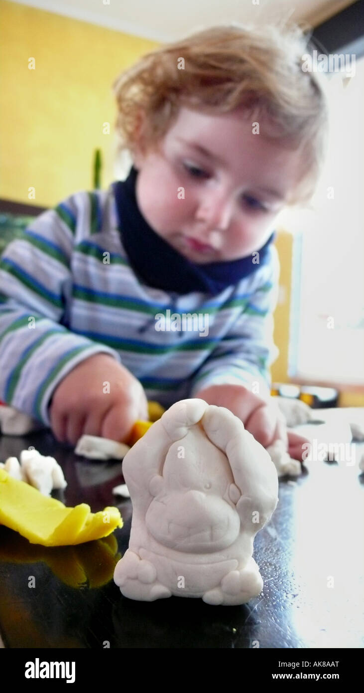 small boy playing with modeling clay Stock Photo - Alamy