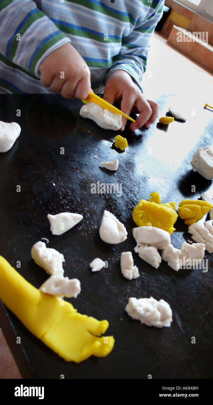 small boy playing with modeling clay Stock Photo - Alamy