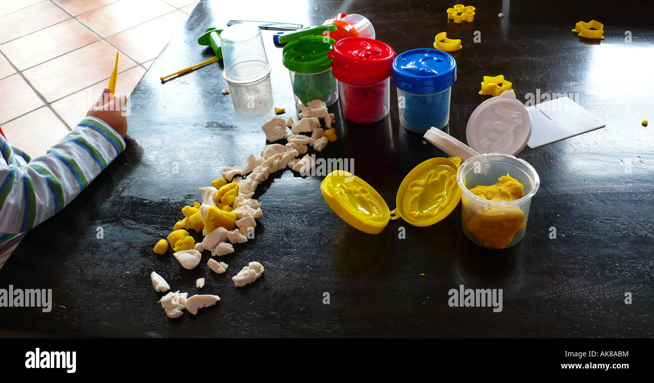 small boy playing with modeling clay Stock Photo - Alamy