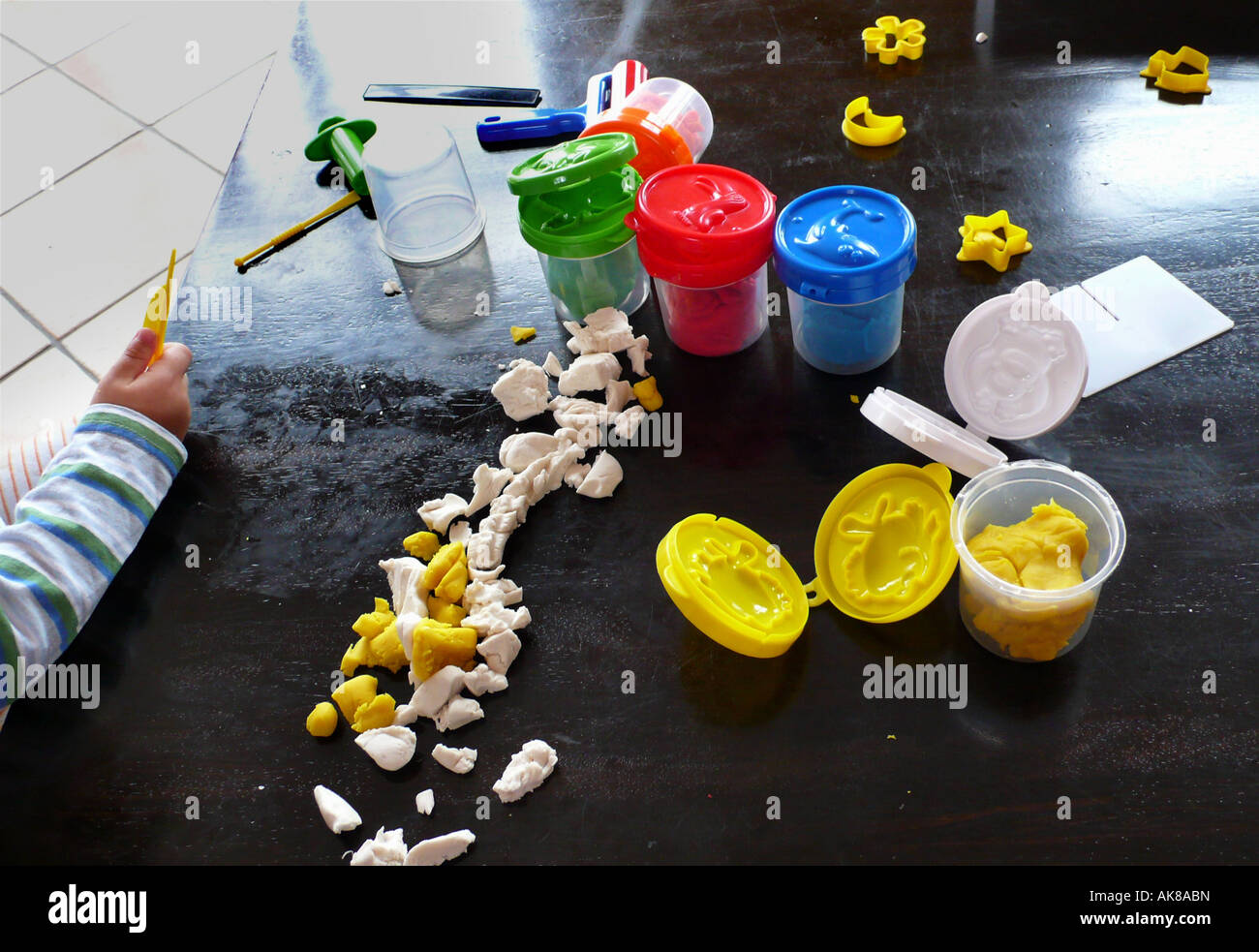 small boy playing with modeling clay Stock Photo - Alamy