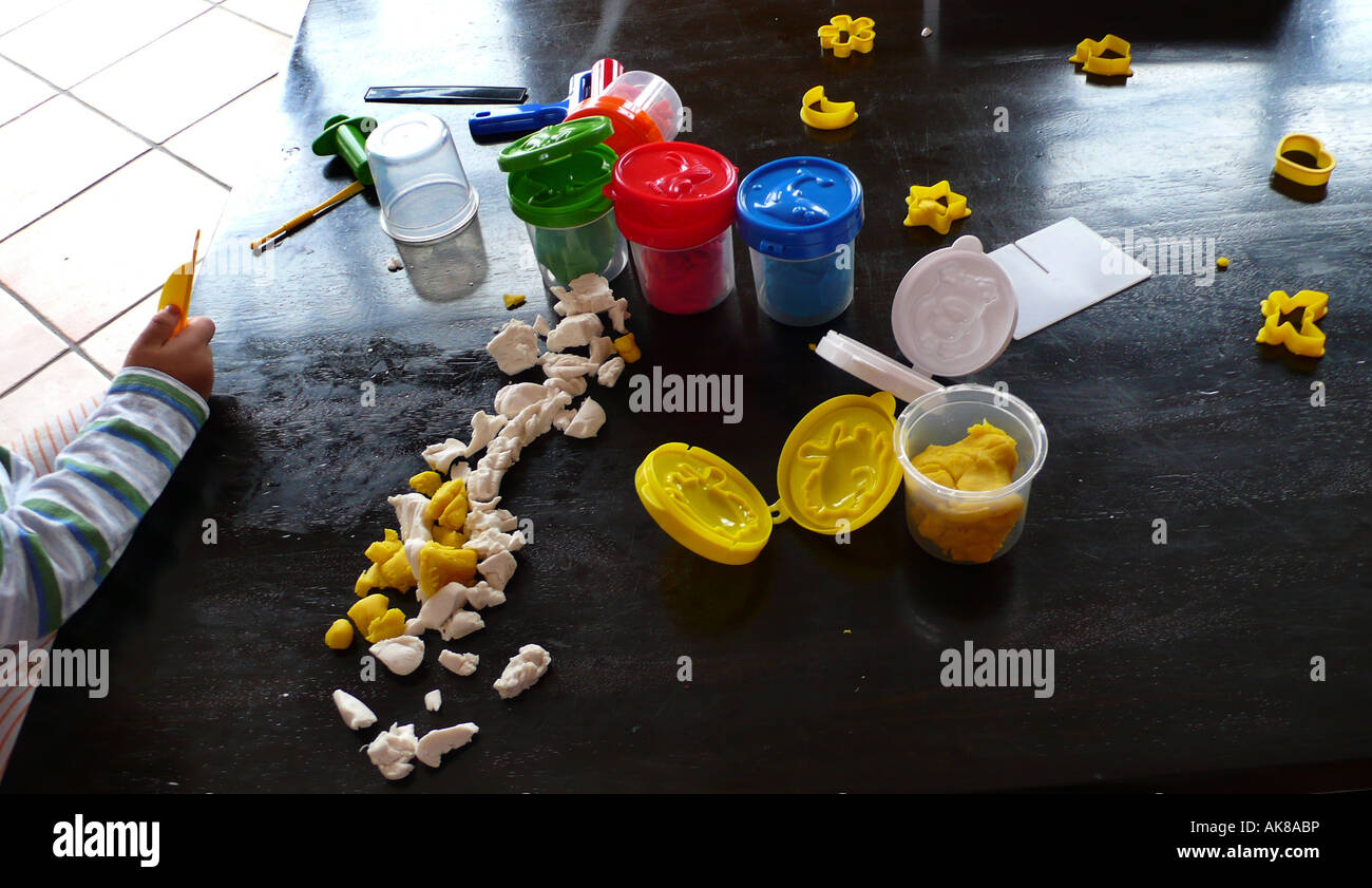 small boy playing with modeling clay Stock Photo - Alamy